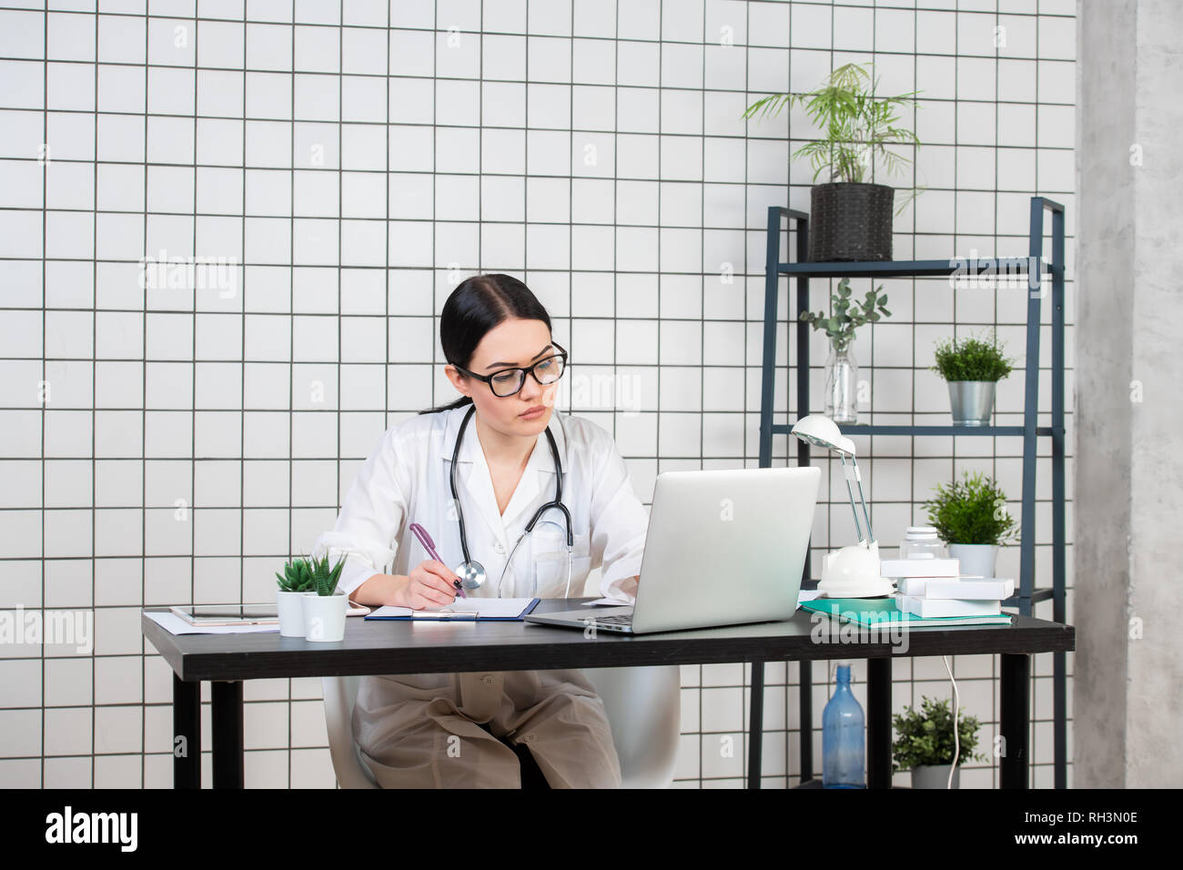 Doctor hand writing prescription using hi-res stock photography and ...
