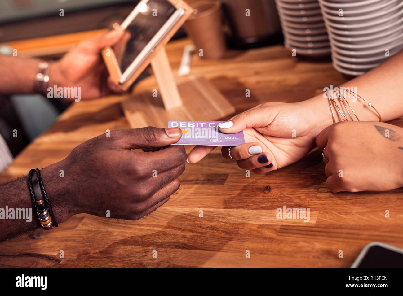 Top view of a debit card being given for payment Stock Photo - Alamy