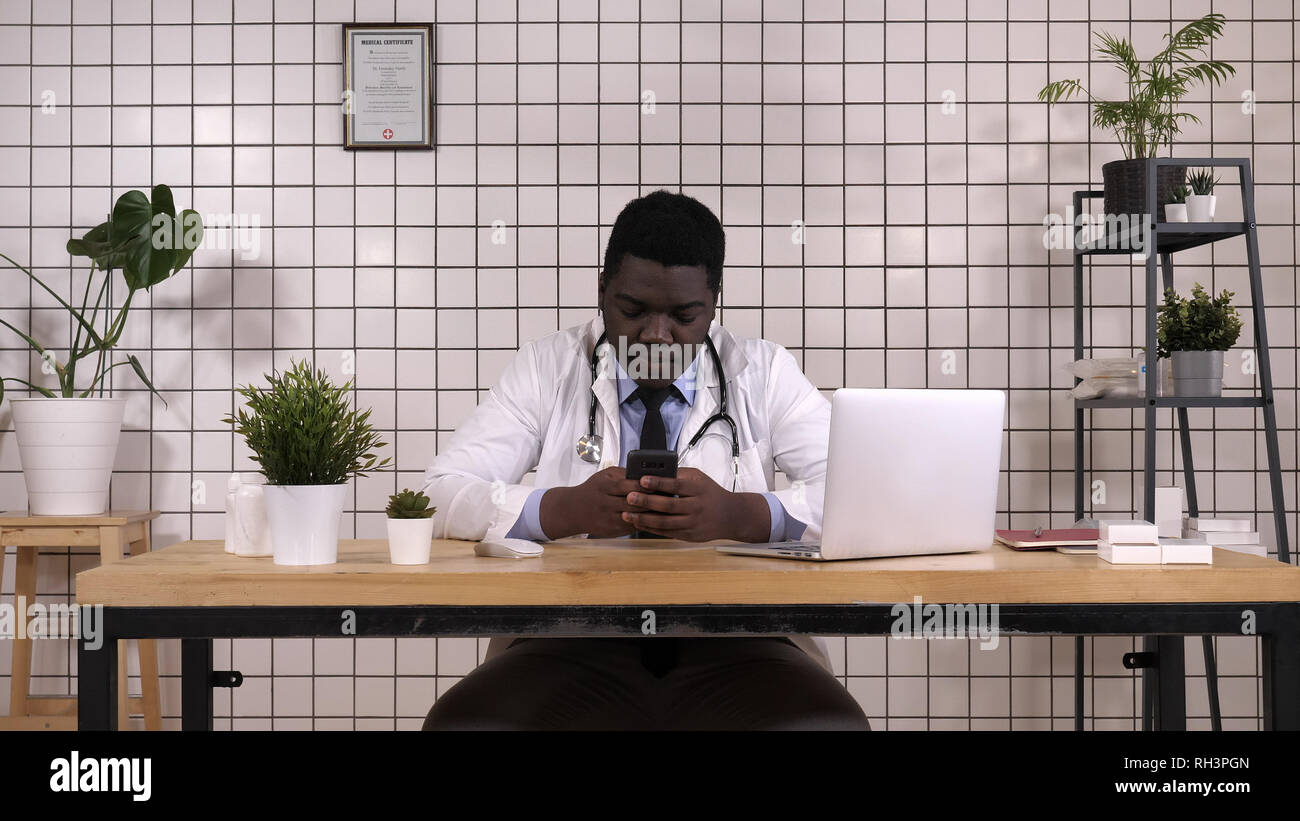 African american doctor and texting hi-res stock photography and images ...