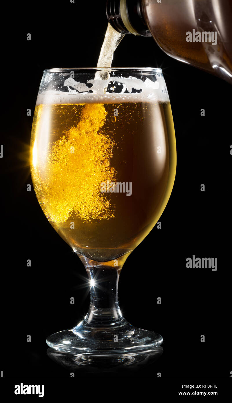 Beer pouring process. Filling a mug with a beer on white background ...