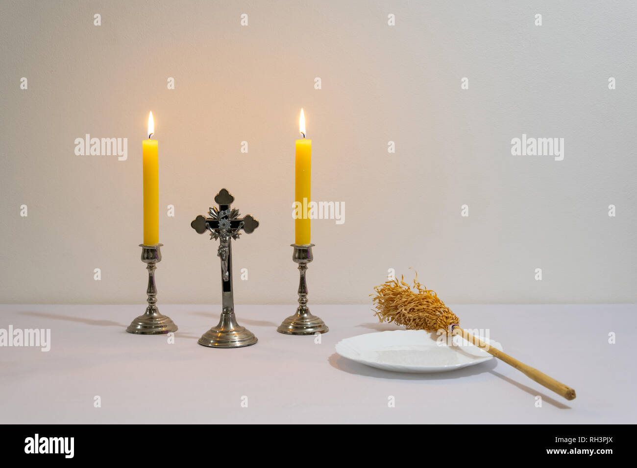 Cross, candles and sprinkler prepared before priest visitation Stock ...