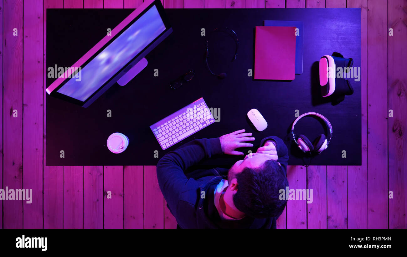 Serious bearded gamer tired but willing to continue playing the game ...