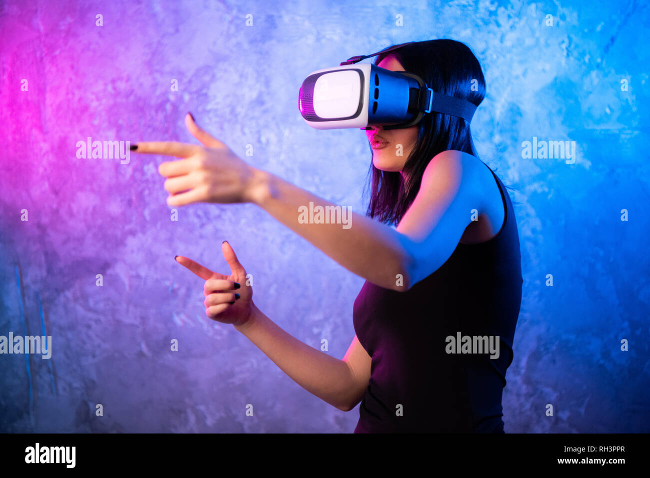 Woman looking with VR device and feeling excite Stock Photo - Alamy