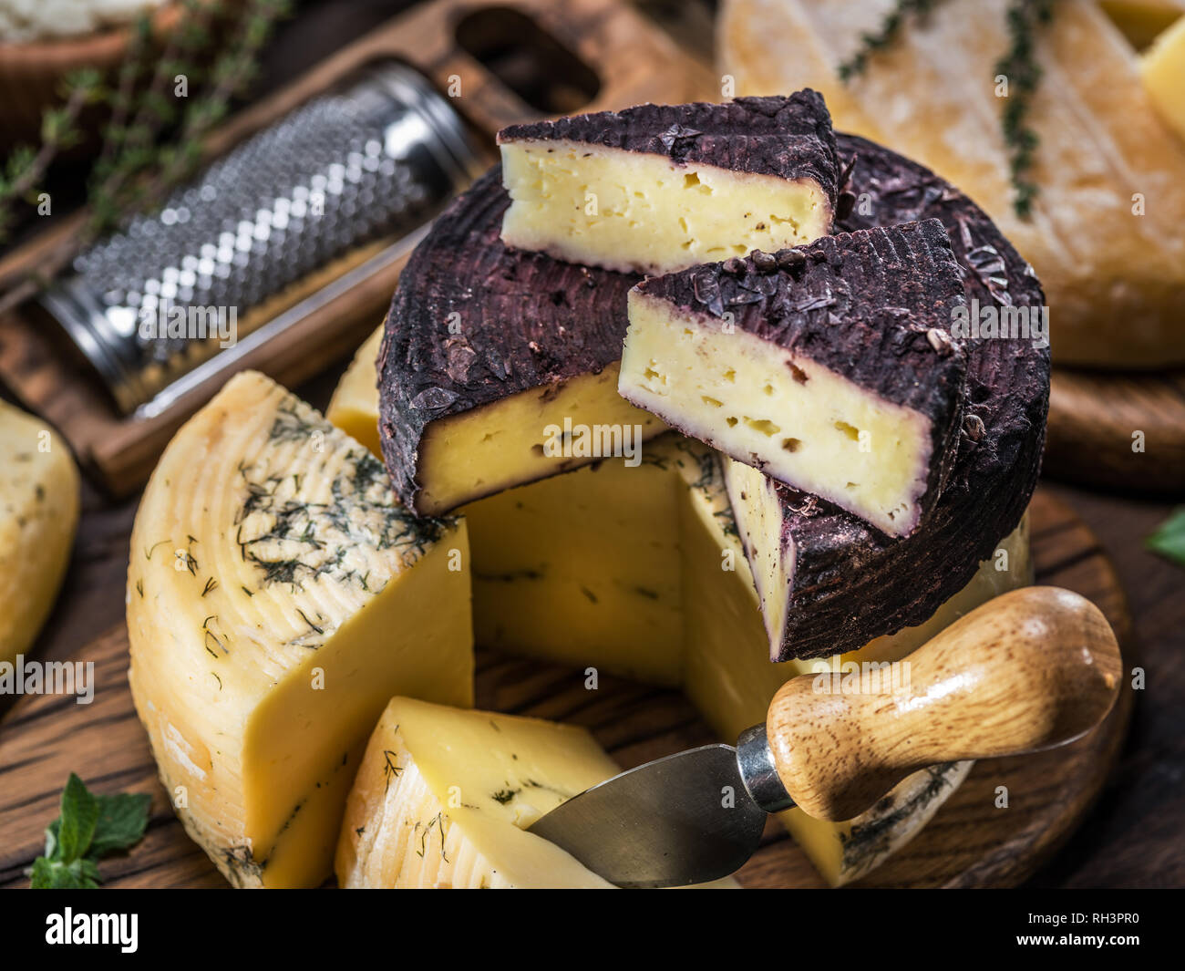 Homemade cheeses on the wooden background. Cheese background Stock ...