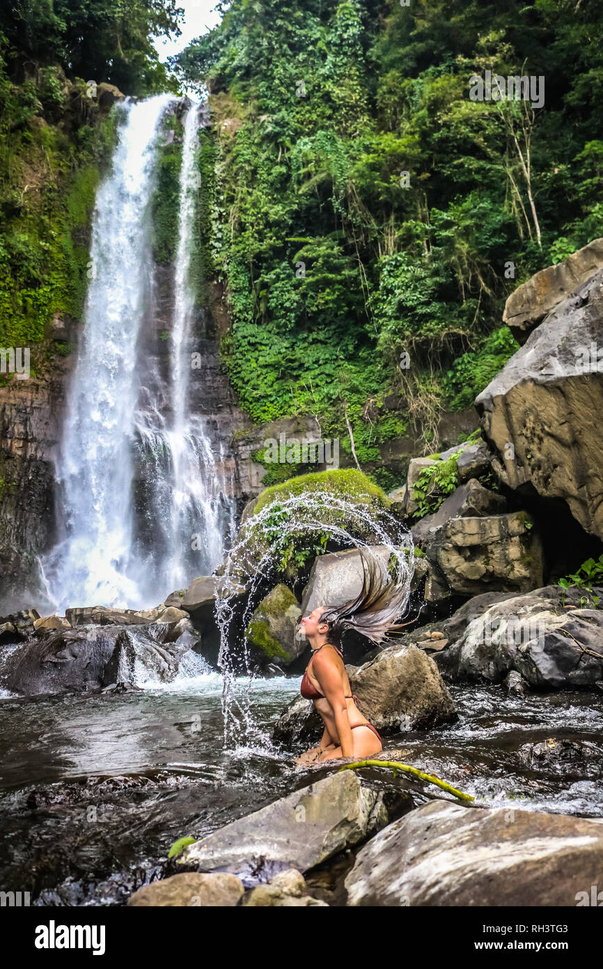 Hair flick under waterfall Stock Photo - Alamy