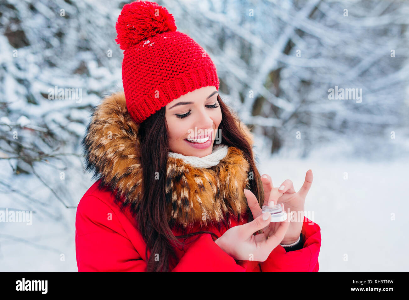 Girl protecting lips with lip balm in winter Stock Photo - Alamy