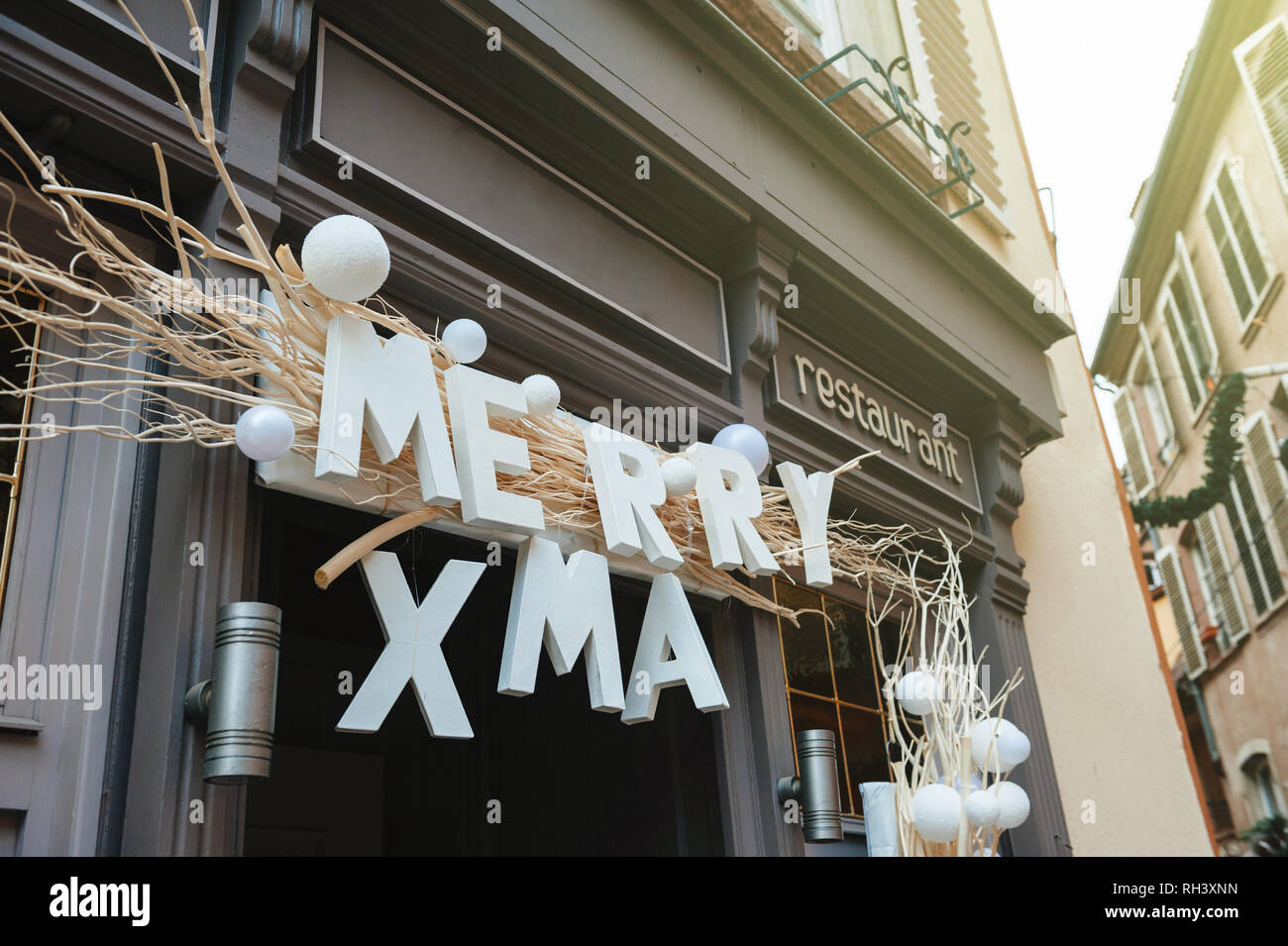 Merry Xmas white letter above the entrance of an French restaurant in ...