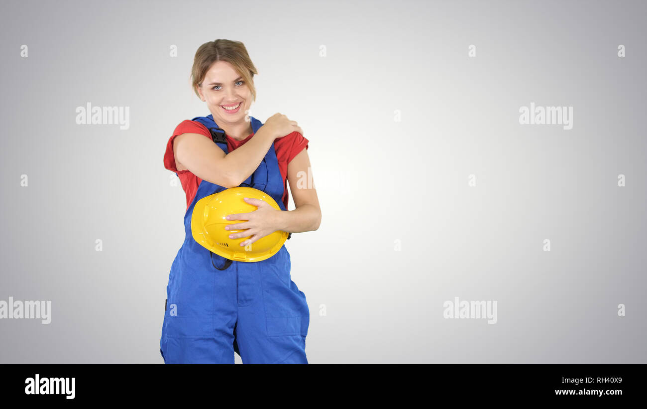 Construction woman laughing at someone behind the camera on gradient ...