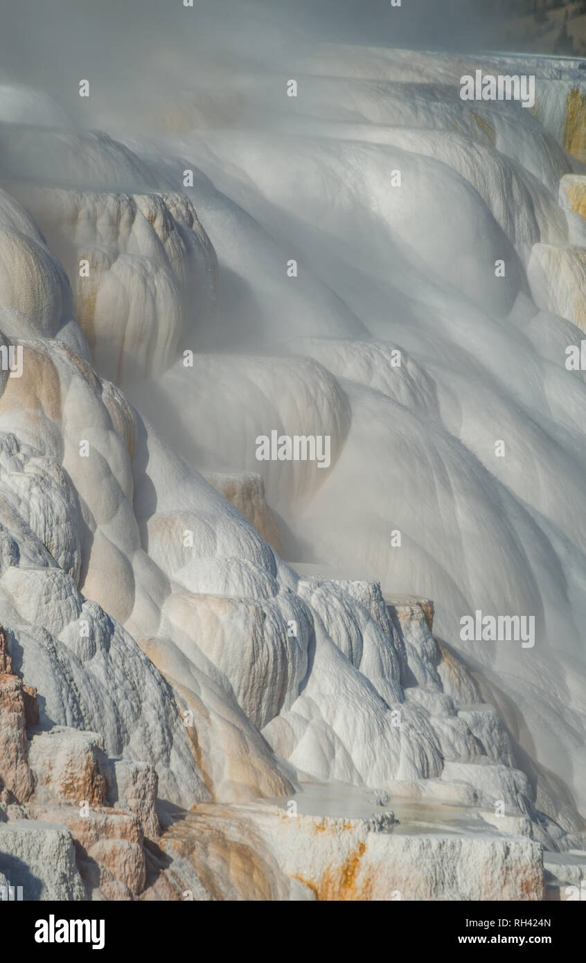 Steam rises from white and gold crystallized calcium carbonate in a ...