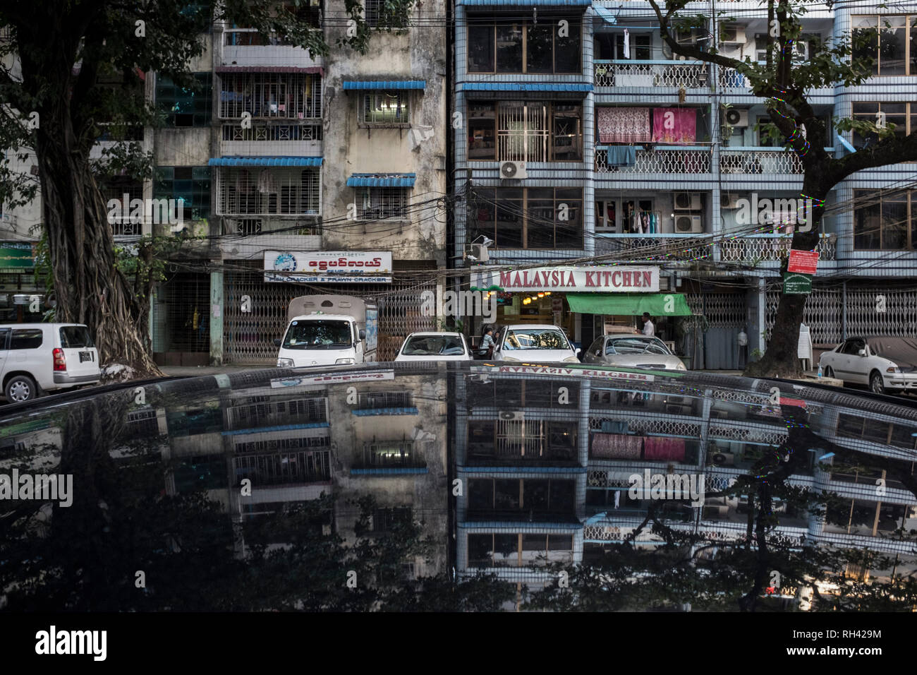 Yangon, Myanmar - 29 September 2016: Buildings reflection at downtown ...