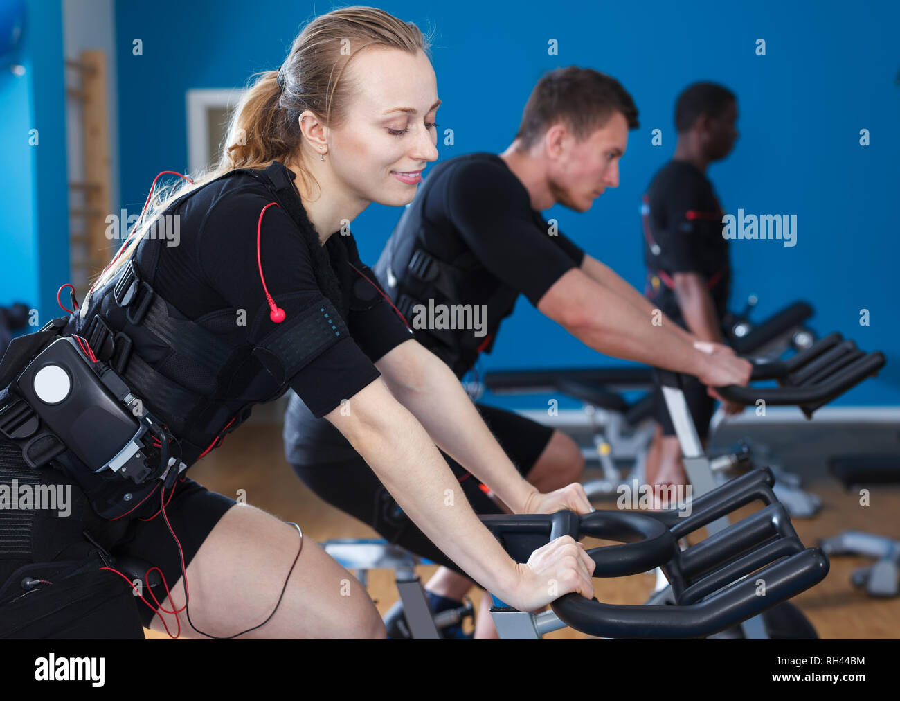 Sports young people performing full-body electric muscle stimulation ...