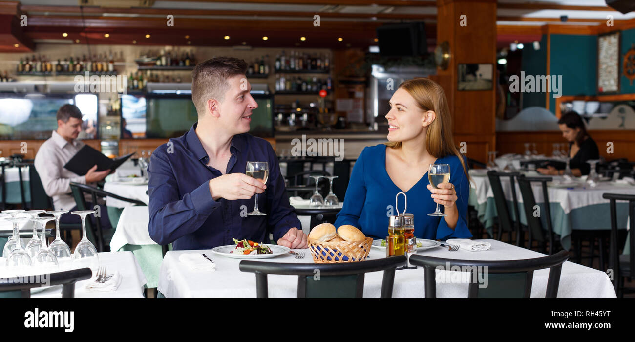 Glad couple spending time in restaurant and having nice talking Stock ...