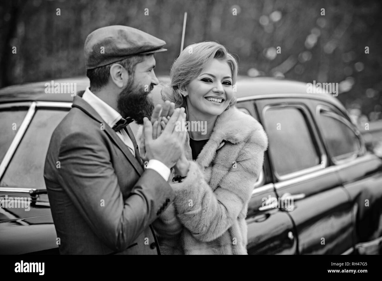 Retro couple at classy vintage car with happy face Stock Photo - Alamy