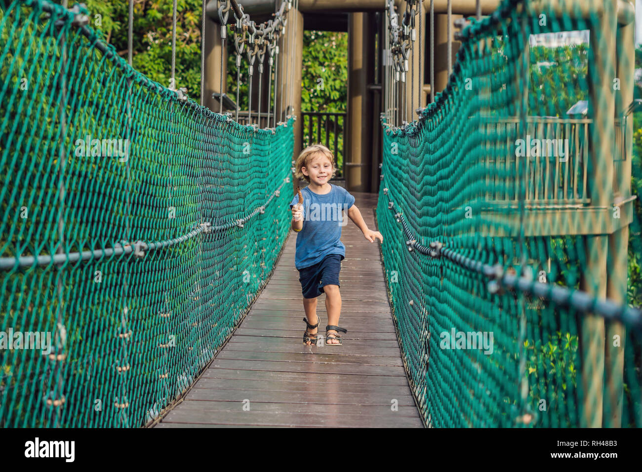 The boy is running on a suspension bridge in Kuala Lumpur, Malaysia ...