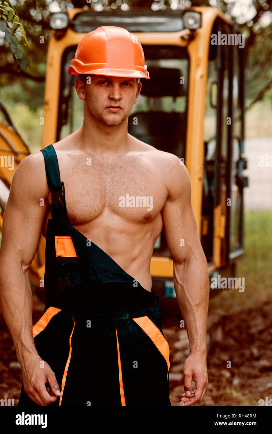Operator concept. Excavator operator on construction site. Muscular ...