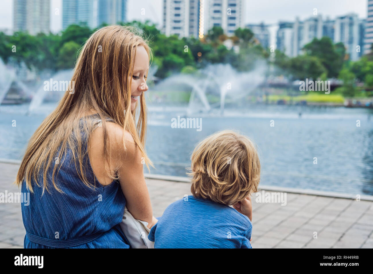 Happy mom with little son enjoying water fountains Stock Photo - Alamy