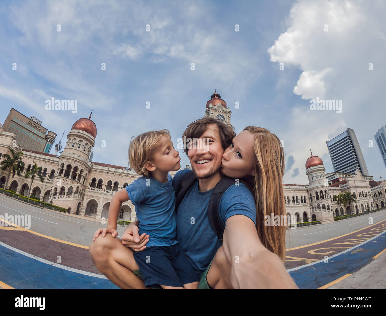 happy family makes selfie on the background on background of Merdeka ...