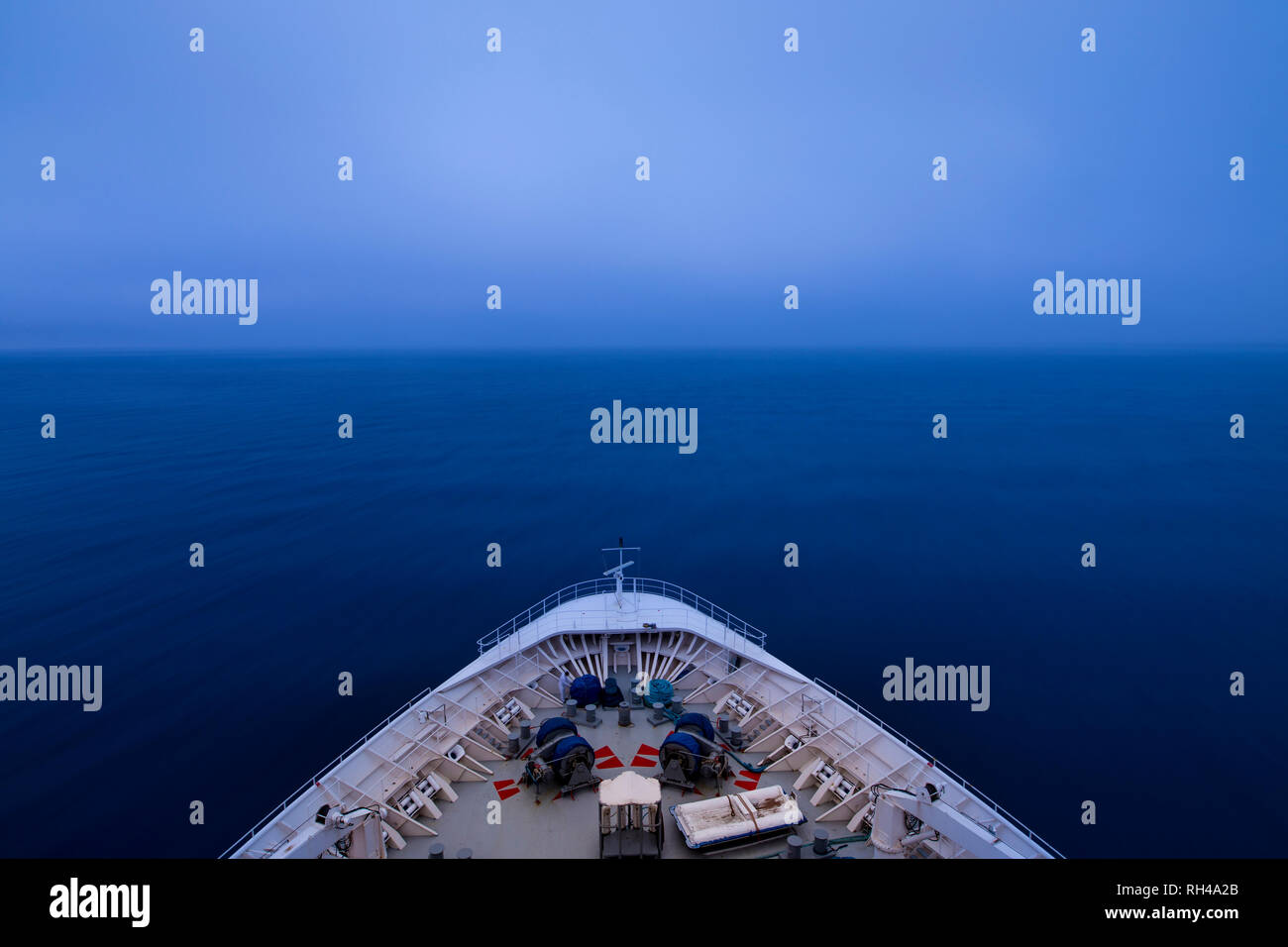 POV shot of bow of a ship sailing into a fog bank in pre dawn hours ...