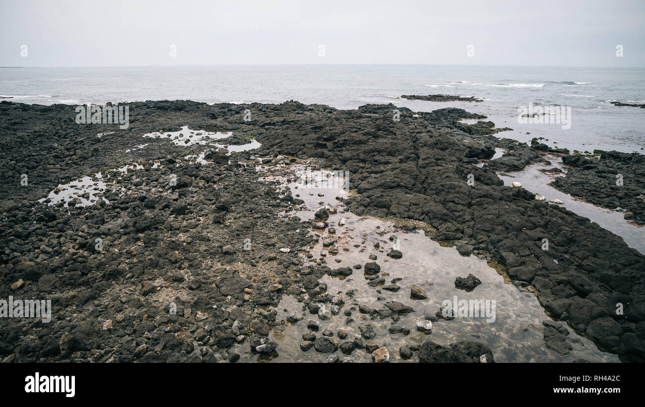Volcanic rock beaches on the coast of Jeju Island, Seogwipo area Stock ...