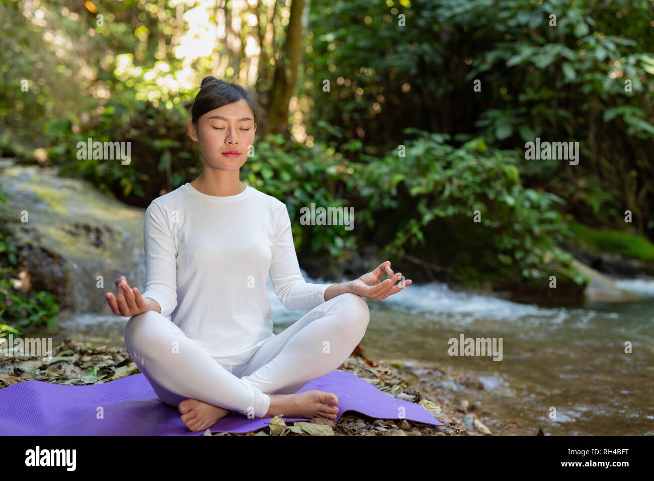 Beautiful girls are playing yoga at the park. Among the natural ...