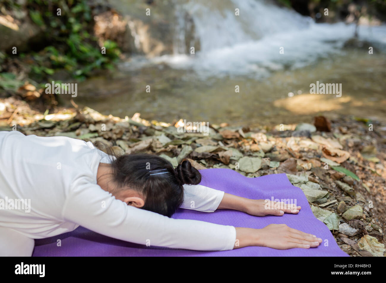 Beautiful girls are playing yoga at the park. Among the natural ...