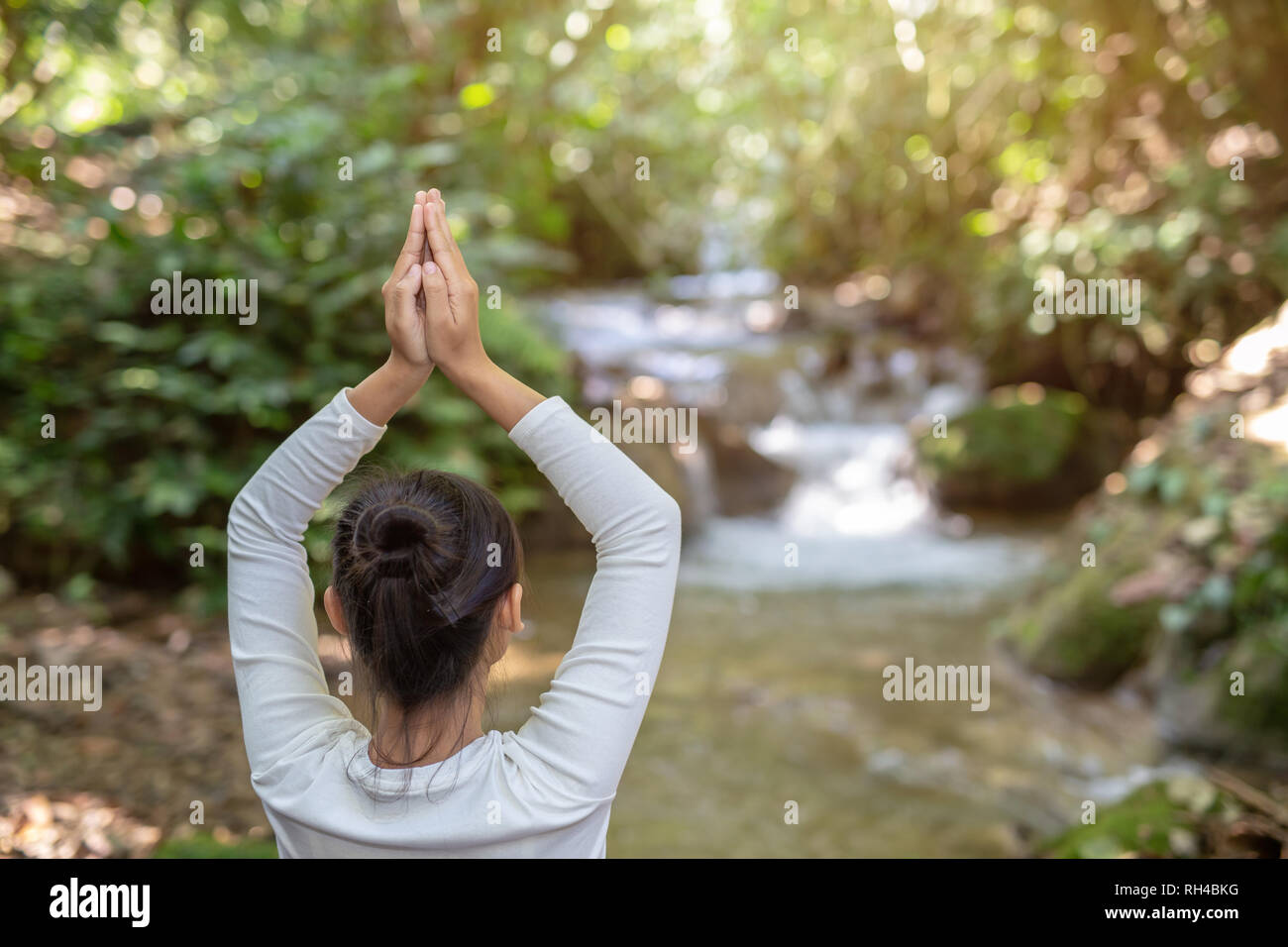 Beautiful girls are playing yoga at the park. Among the natural ...