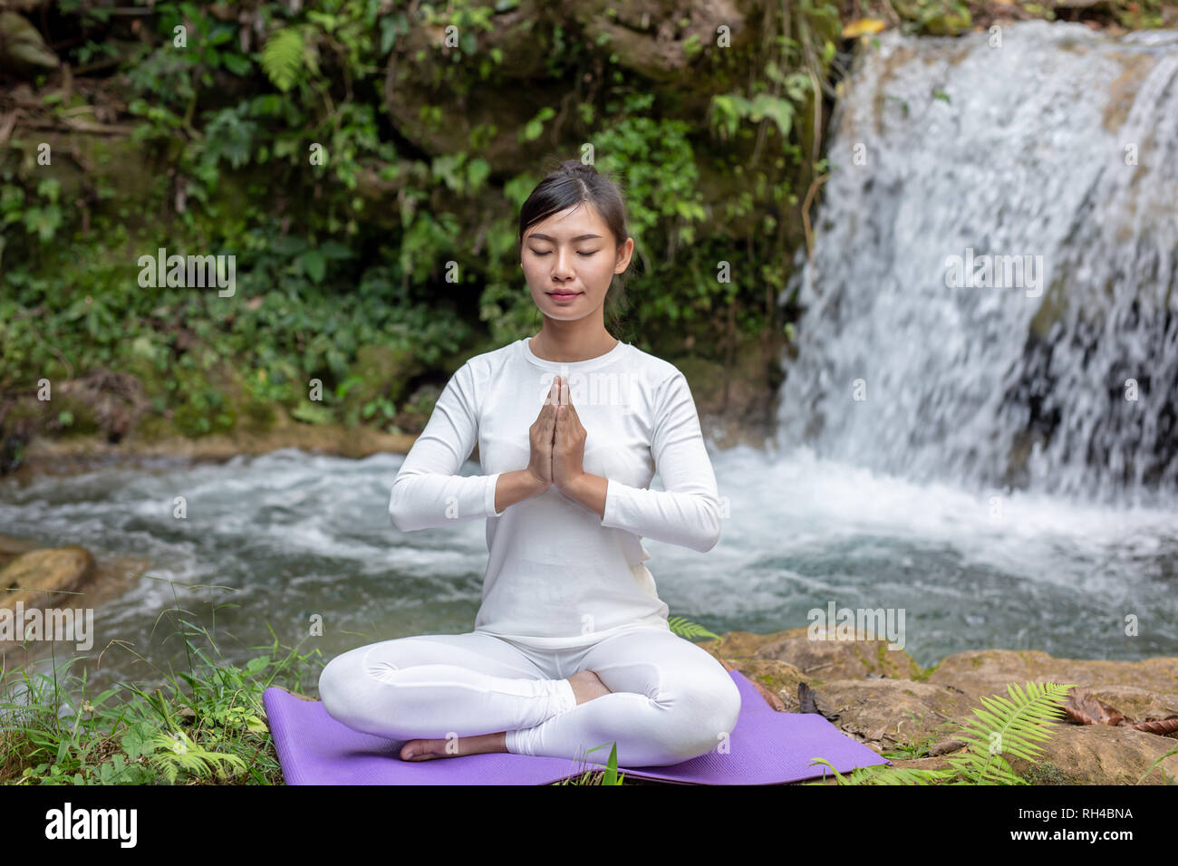 Beautiful girls are playing yoga at the park. Among the natural ...