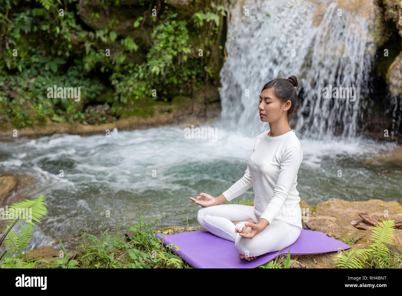 Beautiful girls are playing yoga at the park. Among the natural ...