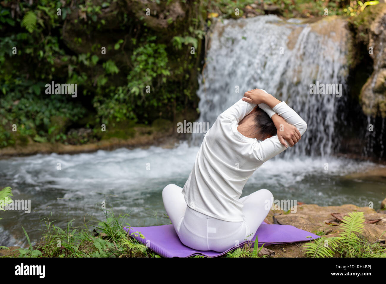 Beautiful girls are playing yoga at the park. Among the natural ...