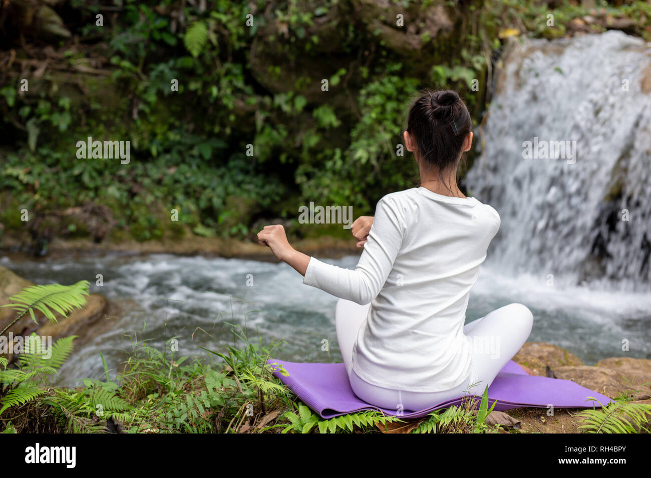 Beautiful girls are playing yoga at the park. Among the natural ...