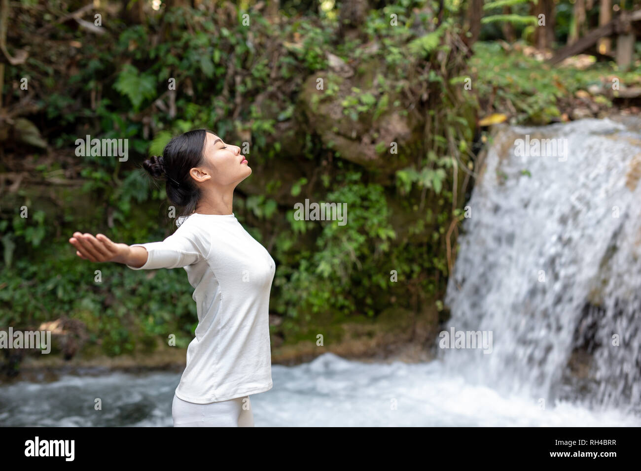 Beautiful girls are playing yoga at the park. Among the natural ...