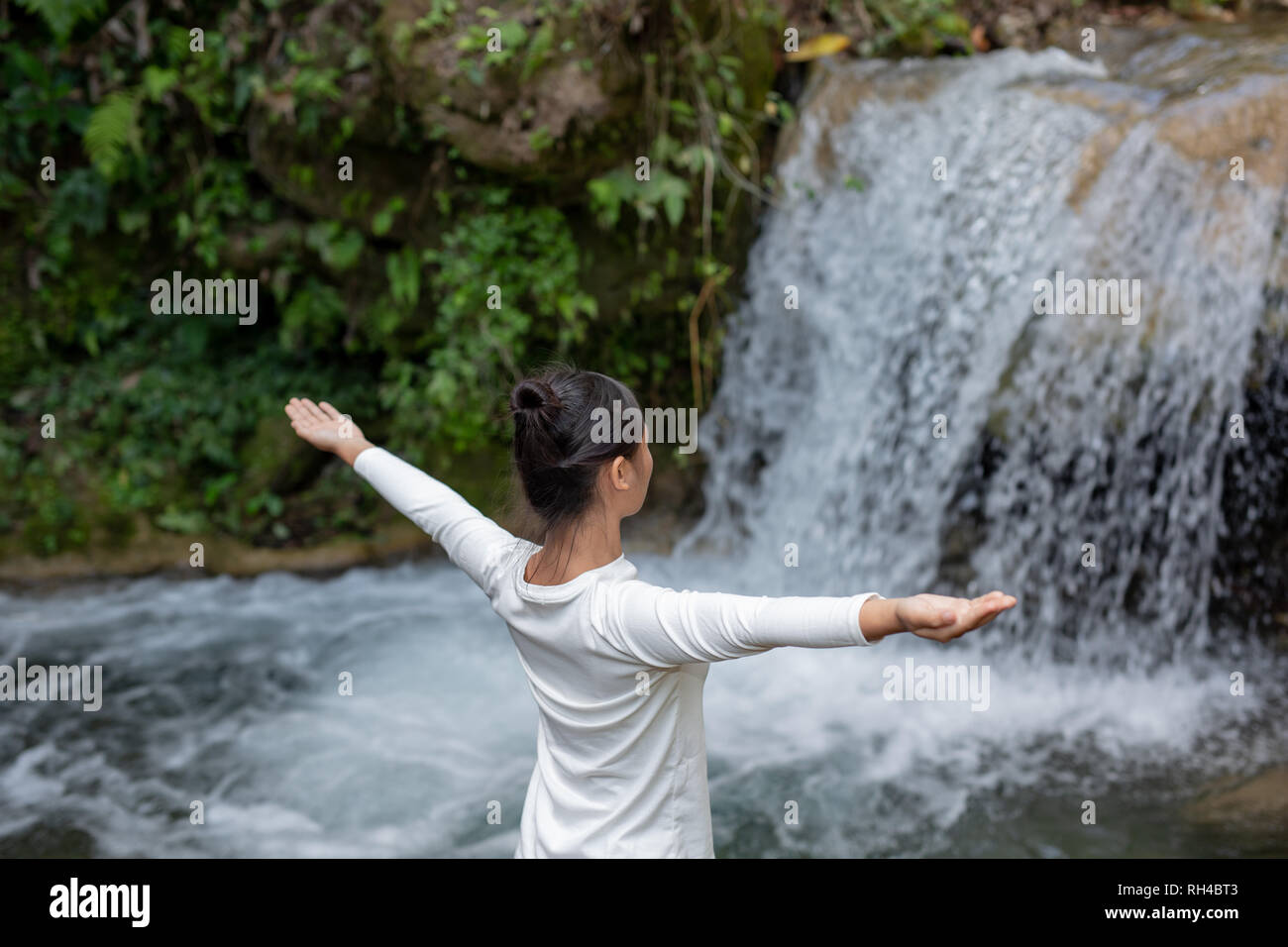 Beautiful girls are playing yoga at the park. Among the natural ...