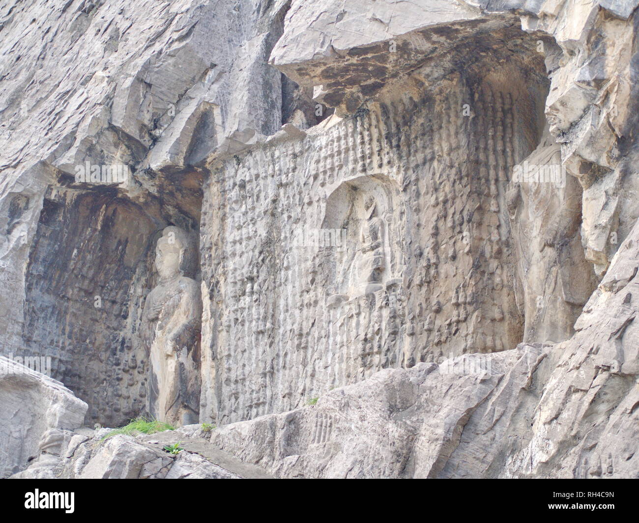 Luoyang Longmen grottoes. Broken Buddha and the stone caves and ...