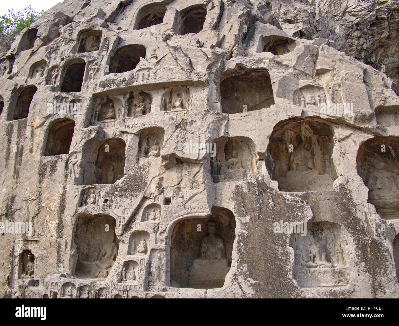 Luoyang Longmen grottoes. Broken Buddha and the stone caves and ...