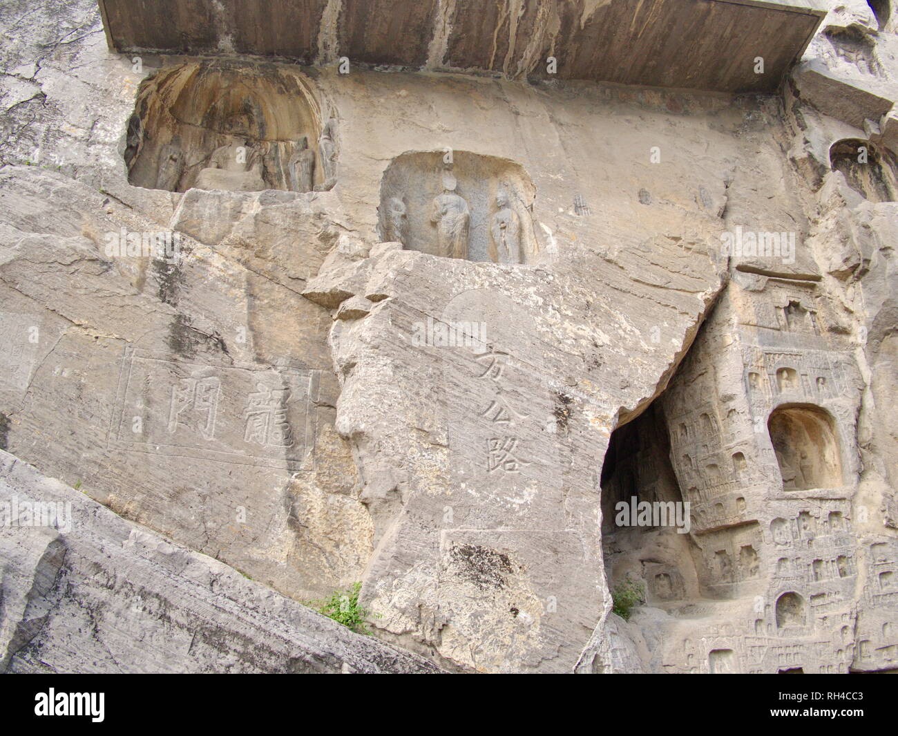 Luoyang Longmen grottoes. Broken Buddha and the stone caves and ...