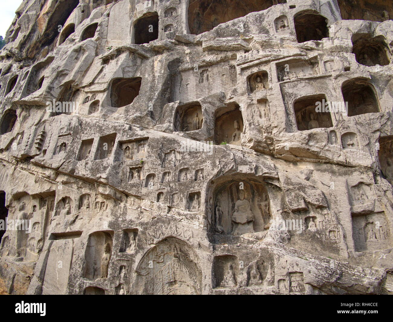 Luoyang Longmen grottoes. Broken Buddha and the stone caves and ...