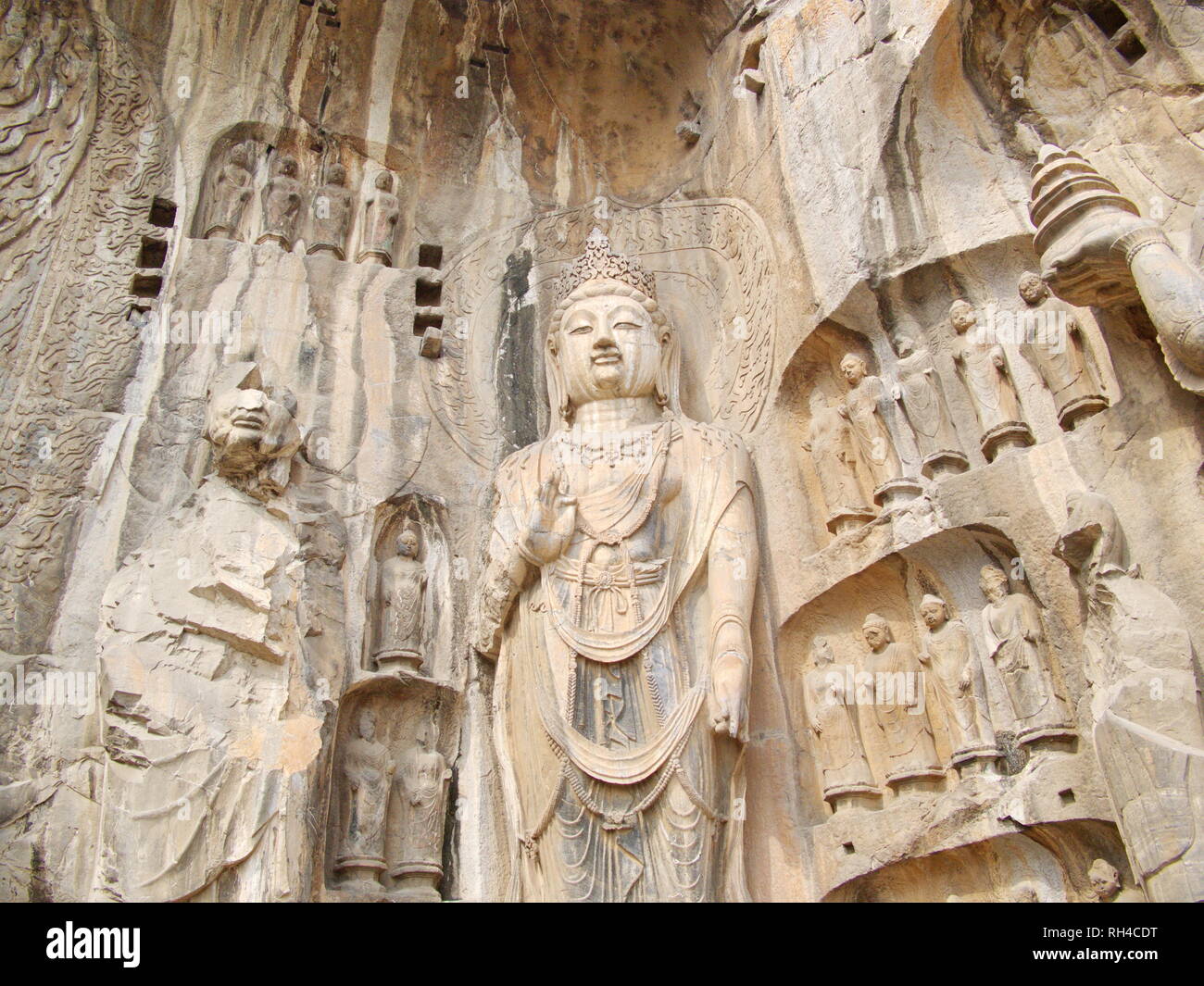 Luoyang Longmen grottoes. Broken Buddha and the stone caves and ...