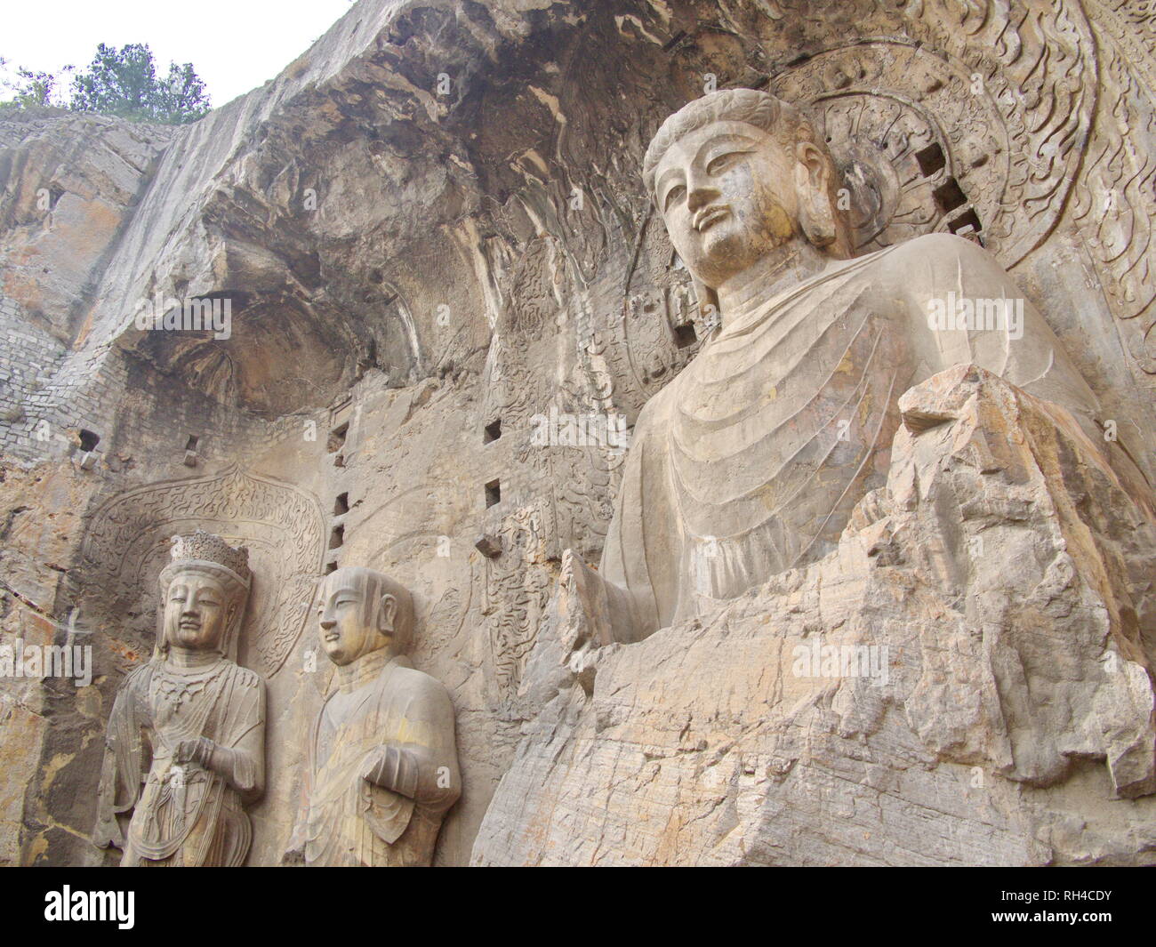 Luoyang Longmen grottoes. Broken Buddha and the stone caves and ...