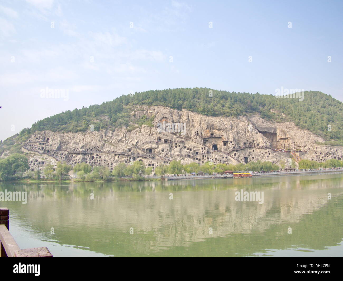 Luoyang Longmen grottoes. Broken Buddha and the stone caves and ...