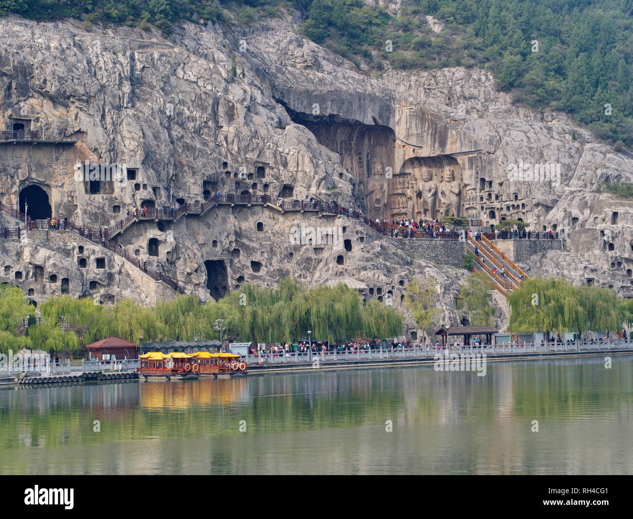 Luoyang Longmen grottoes. Broken Buddha and the stone caves and ...