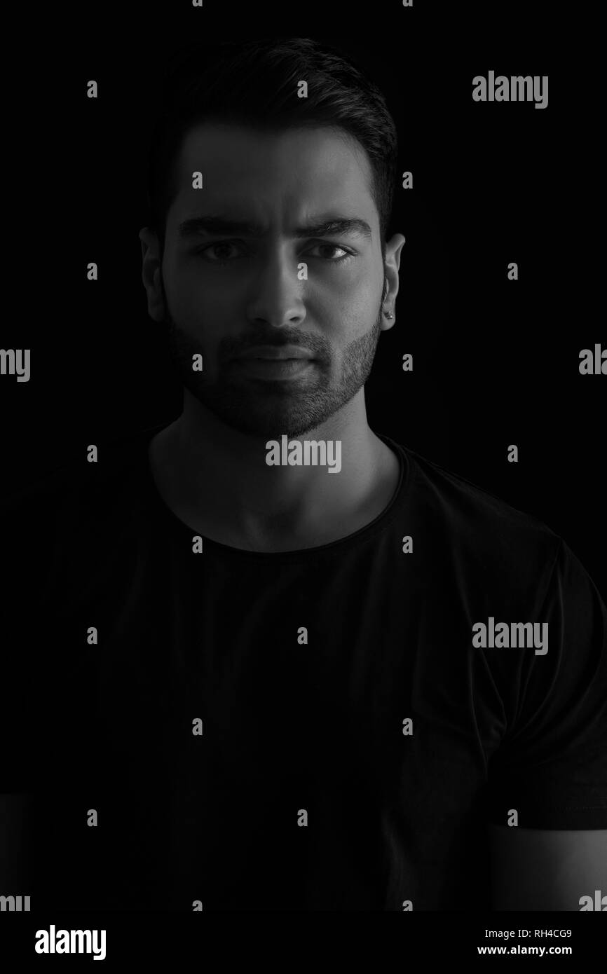 Portrait of a young man standing in the darkness Stock Photo - Alamy