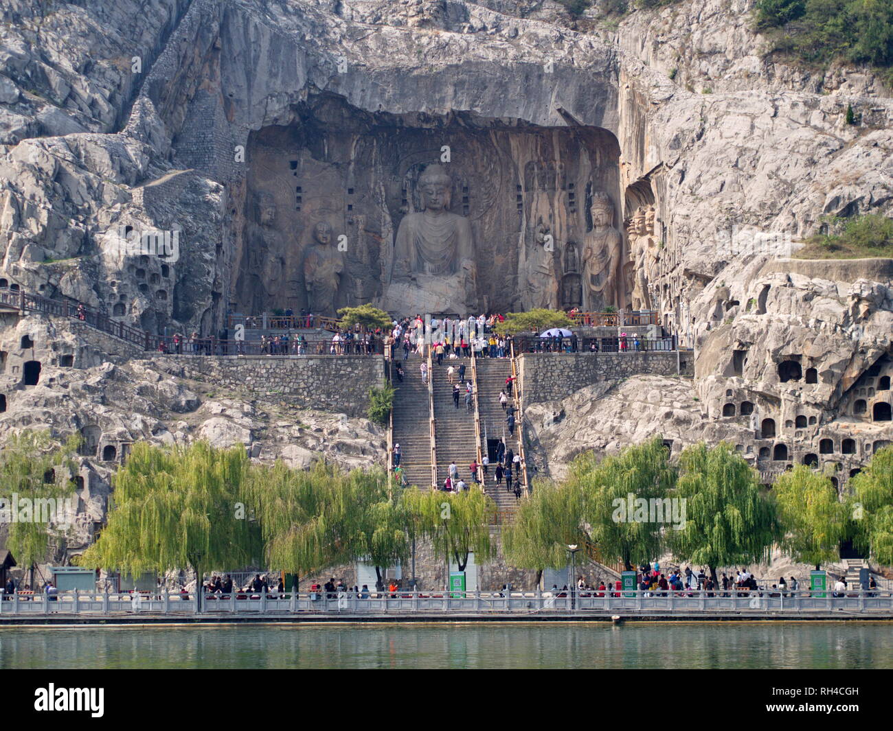 Luoyang Longmen grottoes. Broken Buddha and the stone caves and ...