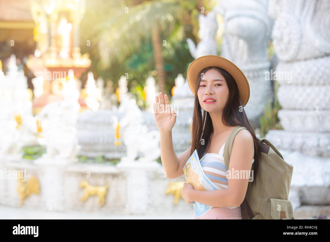 Female tourists hold a map to find places Stock Photo - Alamy
