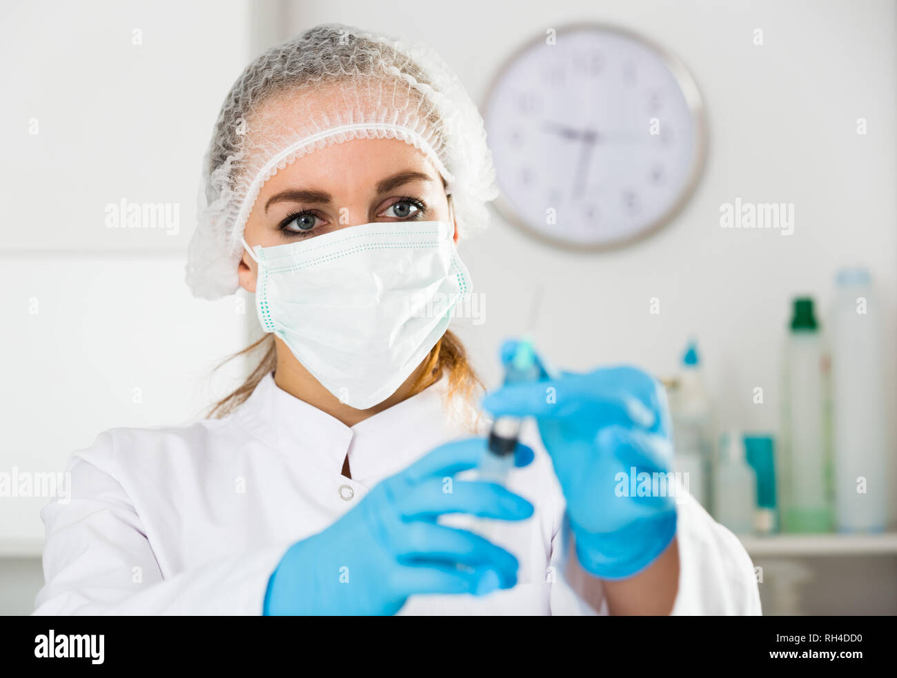 Female nurse preparing injection with syringe in hospital Stock Photo ...