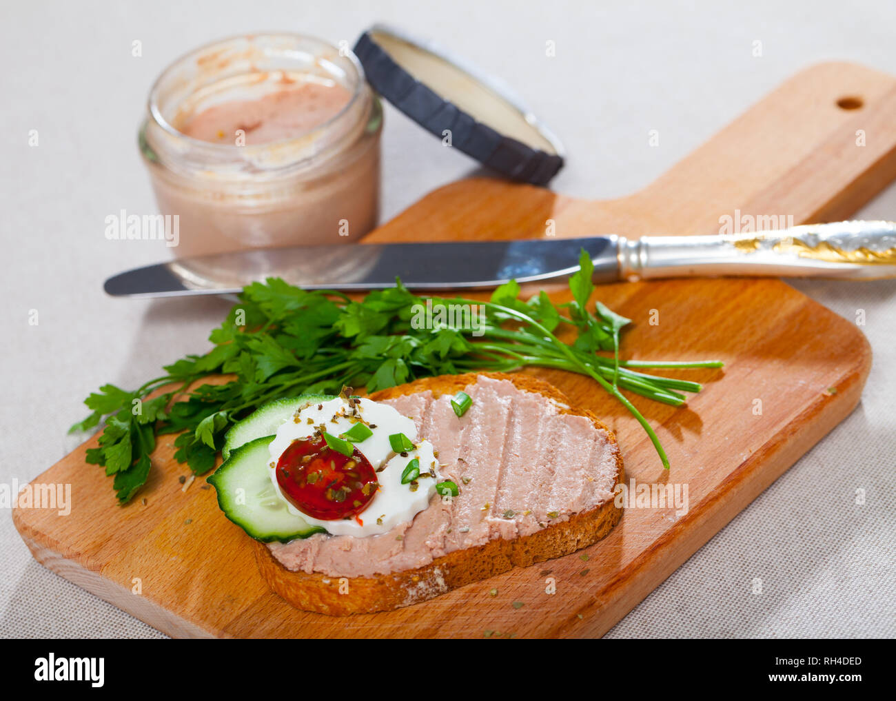 Canape with pate and young cheese at fresh bread, served with greens on ...
