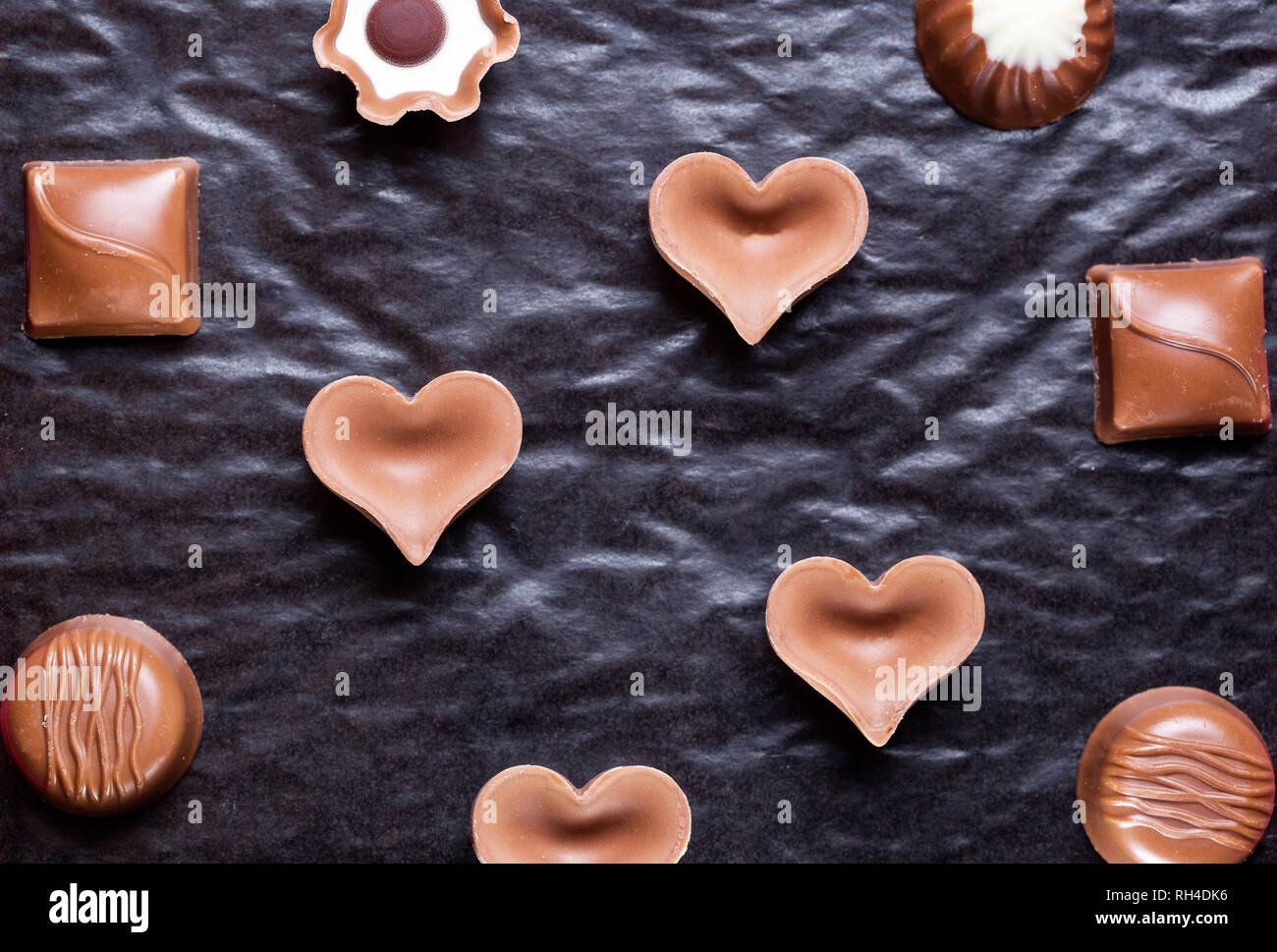 Assortment of chocolate candies over black background sample Stock ...
