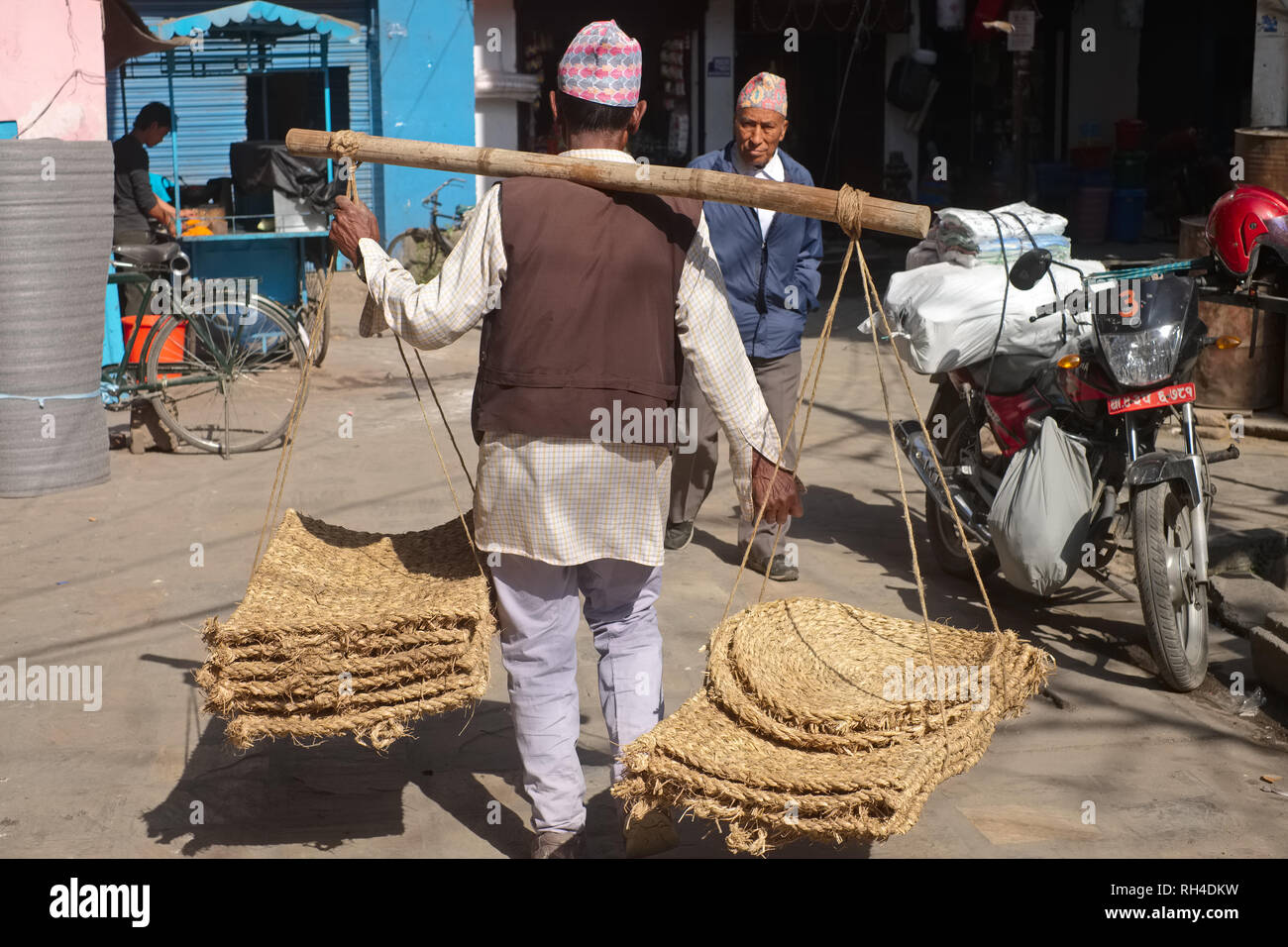 A Nepalese man carrying goods with his shoulder pole (carrying pole ...
