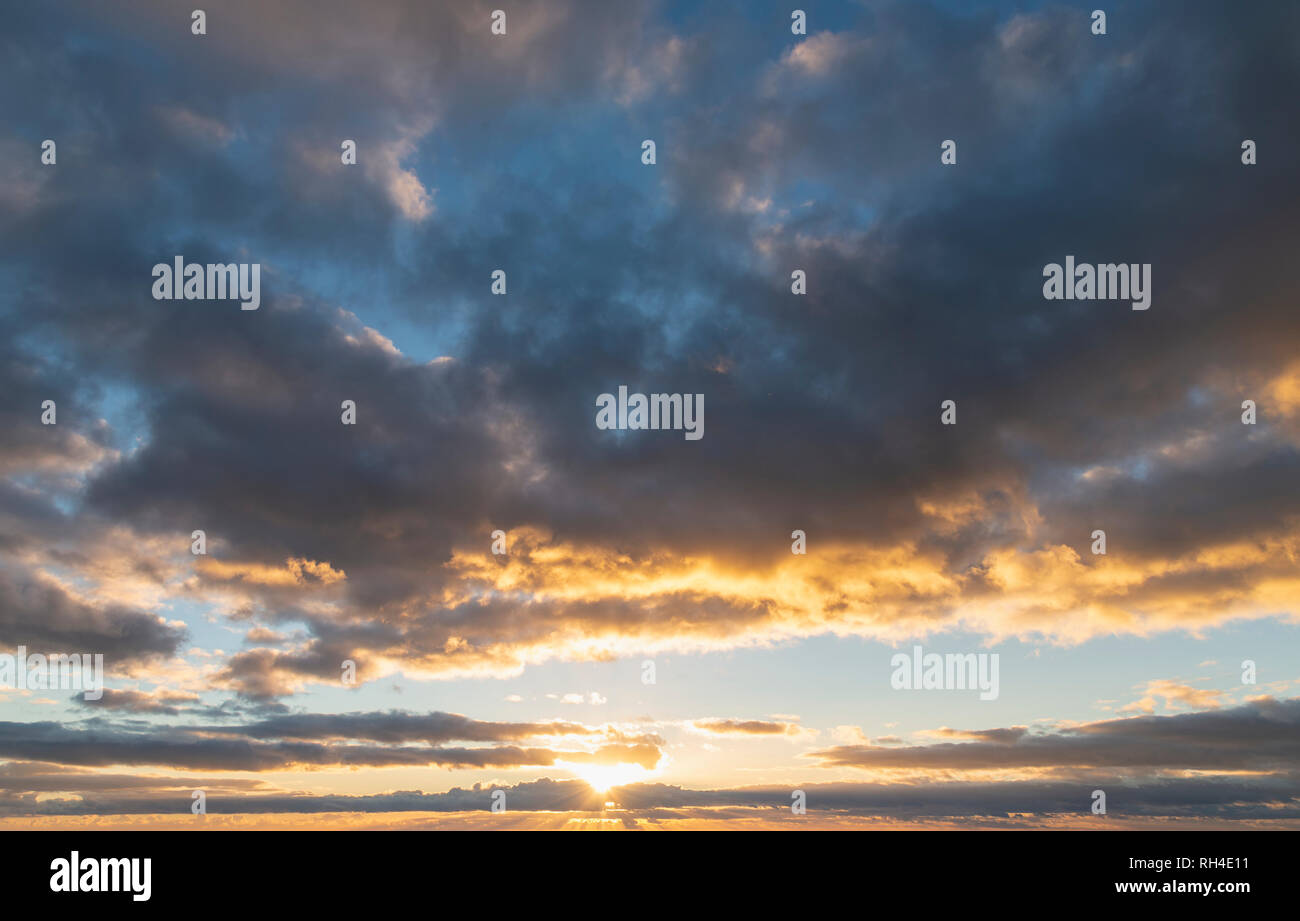 Beautiful colorful golden hour sunset sky with cloud formation and ...