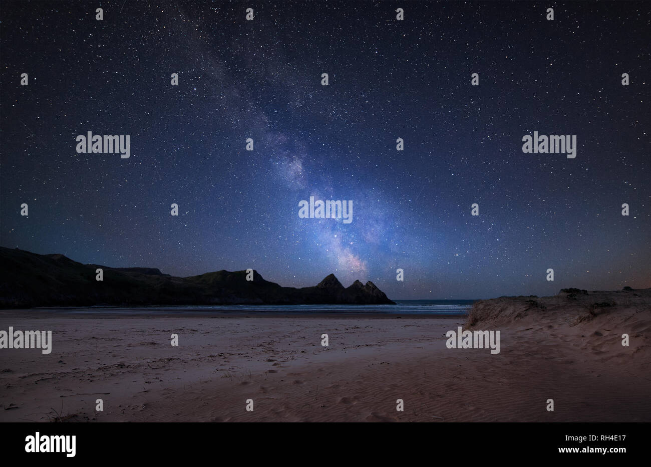 Stunning vibrant Milky Way composite image over landscape of yellow ...