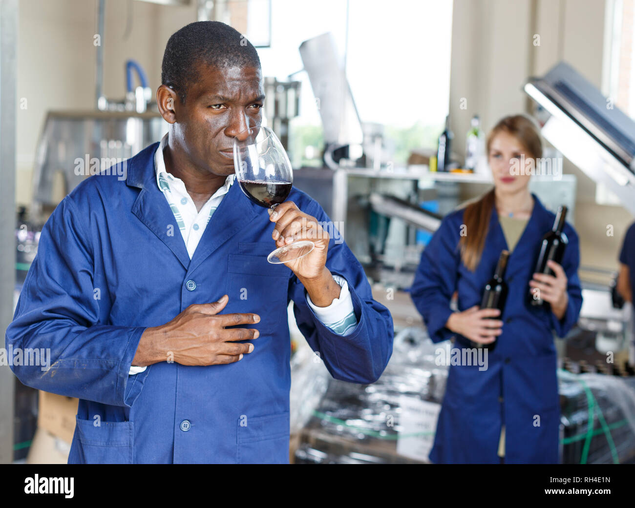 Confident male worker of winery testing new wine in glass Stock Photo ...